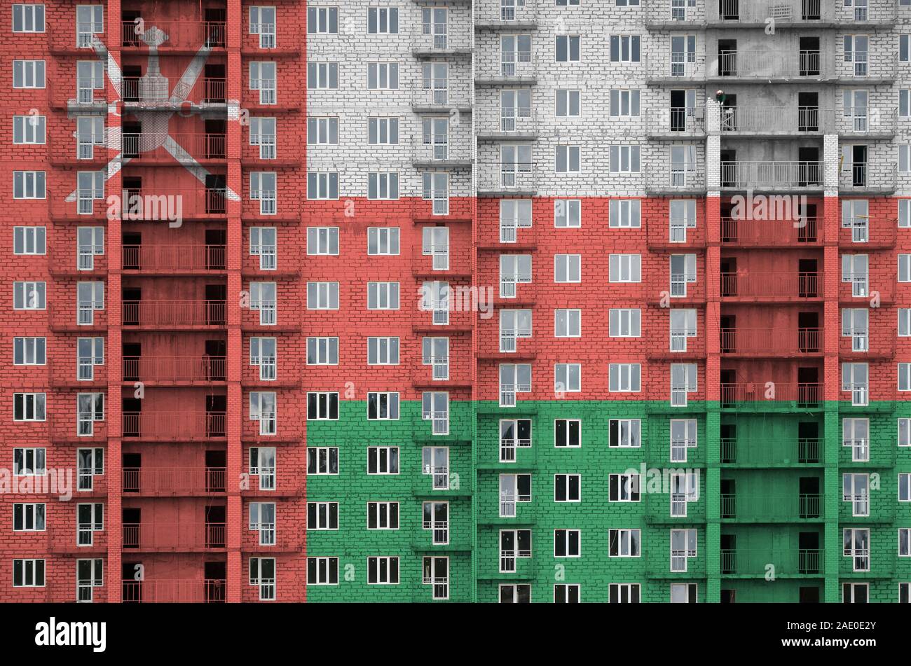 Oman flag depicted in paint colors on multi-storey residental building ...