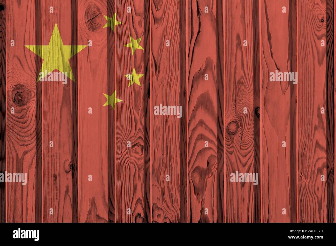 China flag depicted in bright paint colors on old wooden wall close up ...