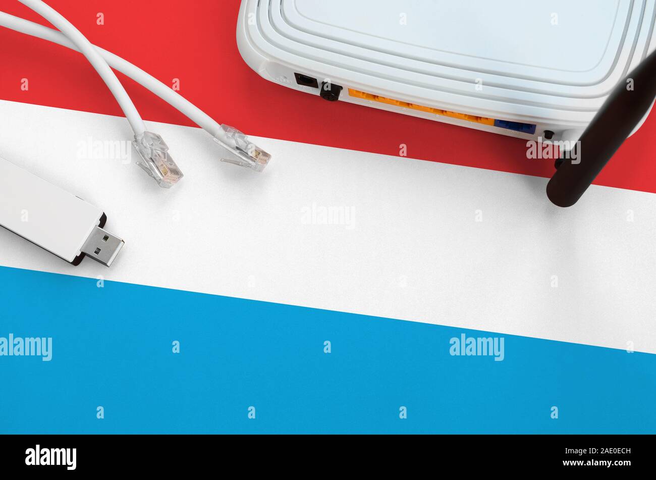 Luxembourg flag depicted on table with internet rj45 cable, wireless ...