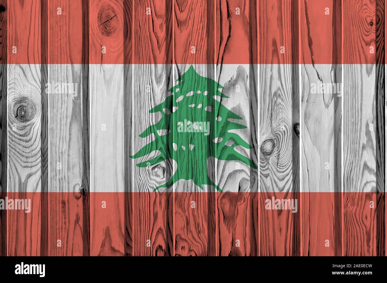 Lebanon flag depicted in bright paint colors on old wooden wall close ...
