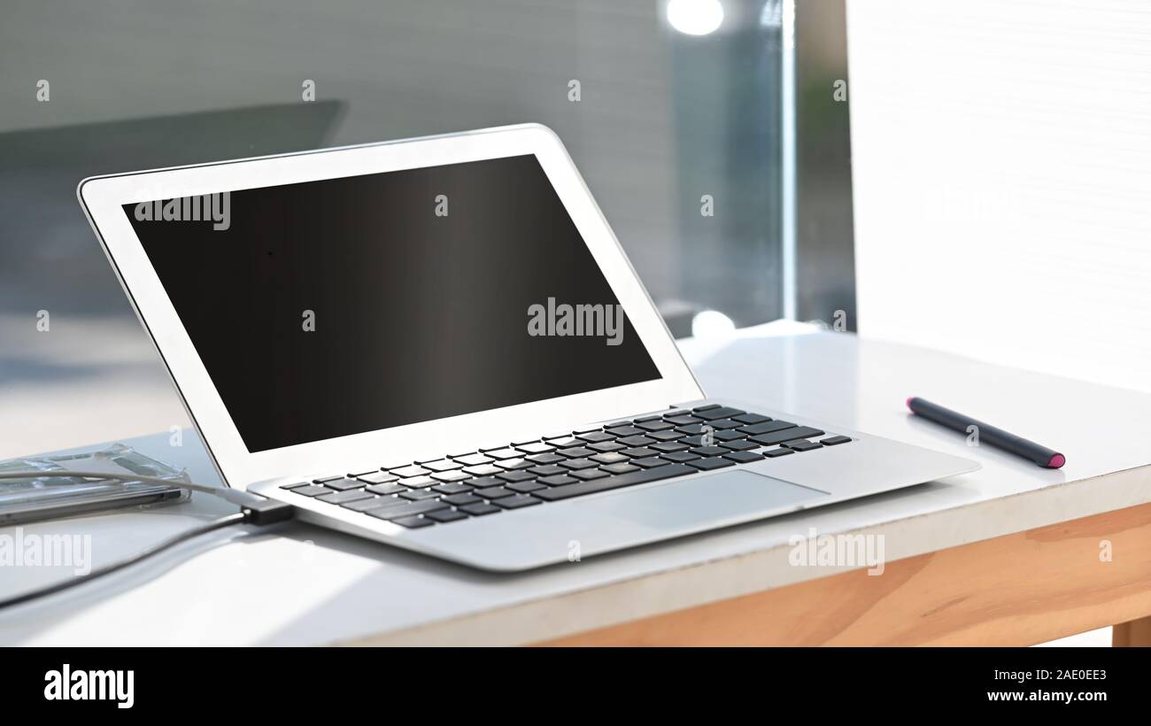 Small laptop computer on fixed table Stock Photo - Alamy