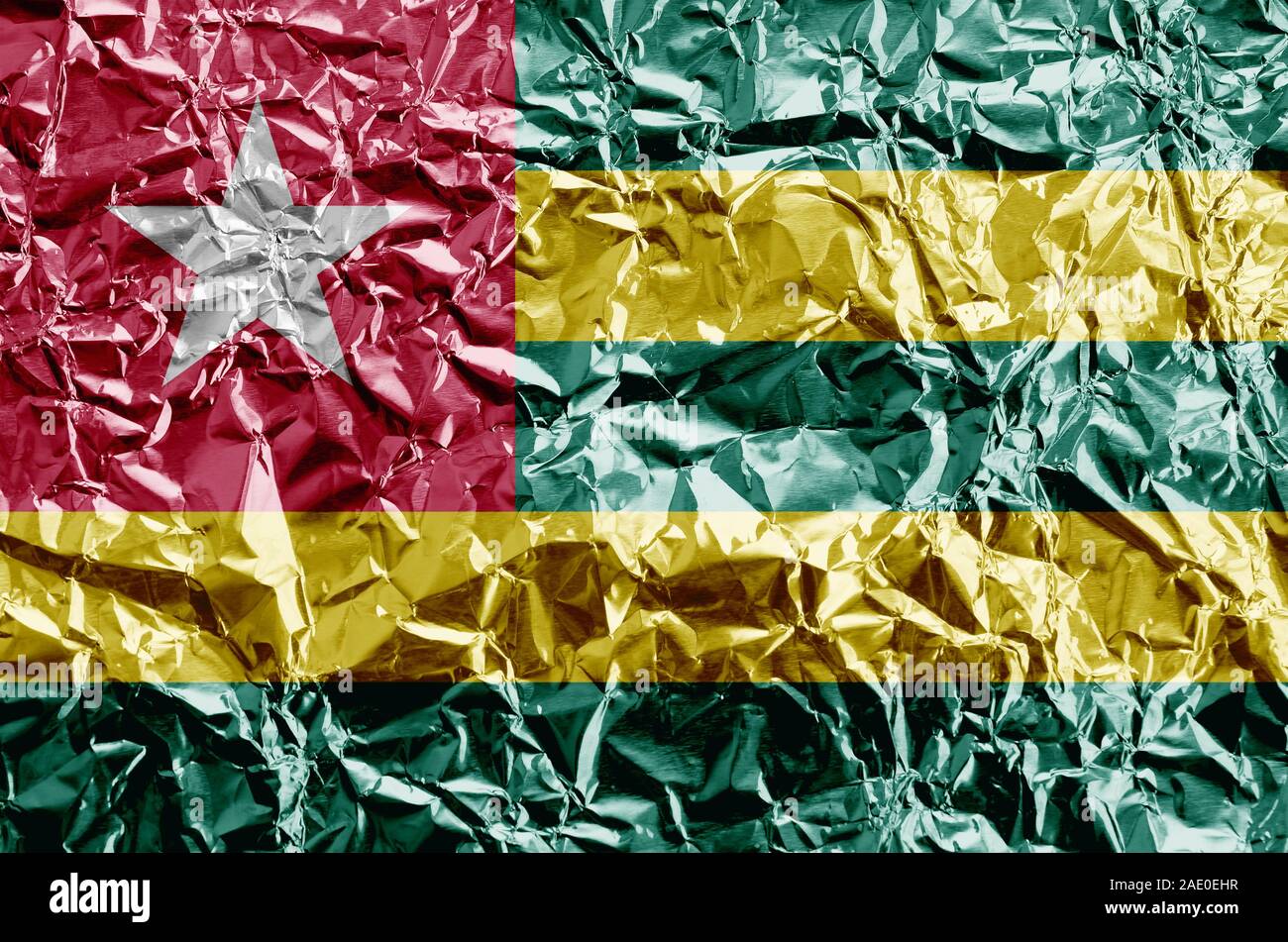 Togo flag depicted in paint colors on shiny crumpled aluminium foil ...