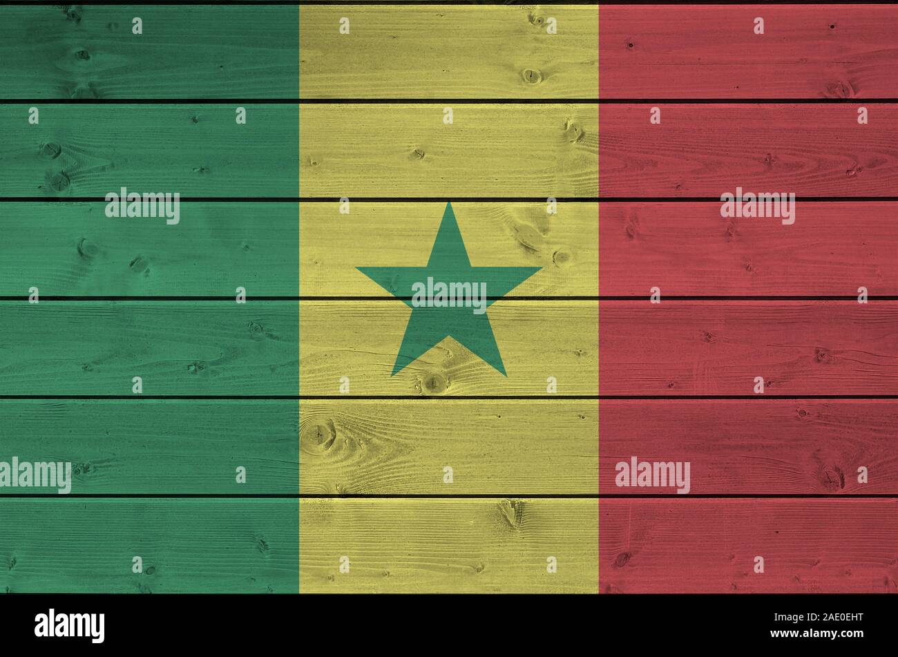 Senegal flag depicted in bright paint colors on old wooden wall close ...