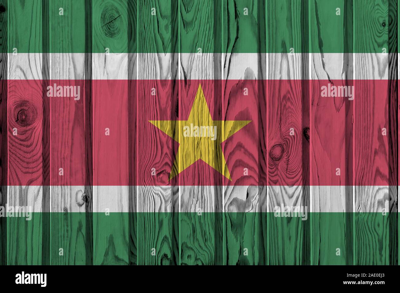 Suriname flag depicted in bright paint colors on old wooden wall close ...