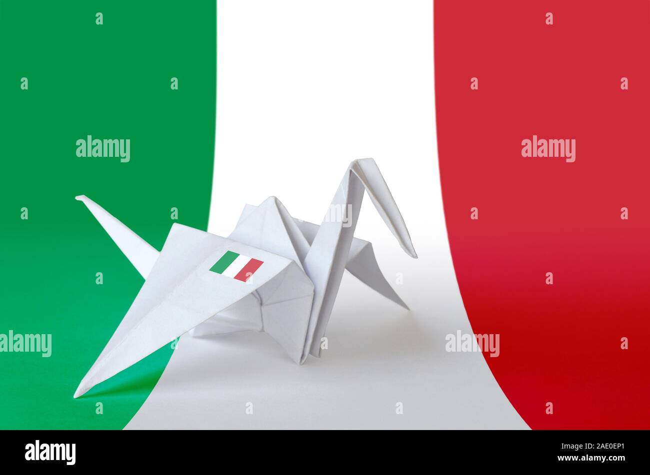 Italy flag depicted on paper origami crane wing. Oriental handmade arts ...