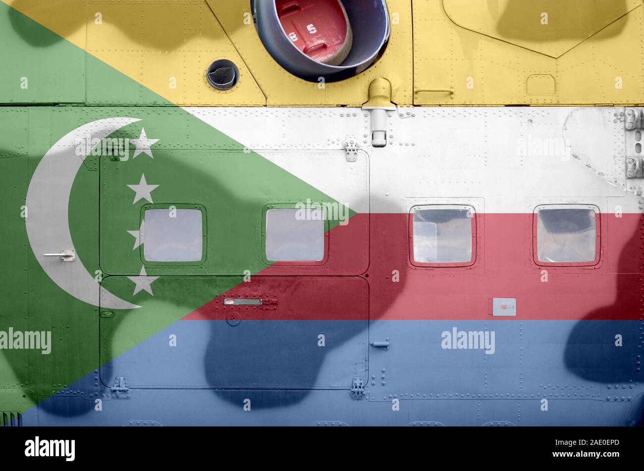 Comoros flag depicted on side part of military armored helicopter close ...