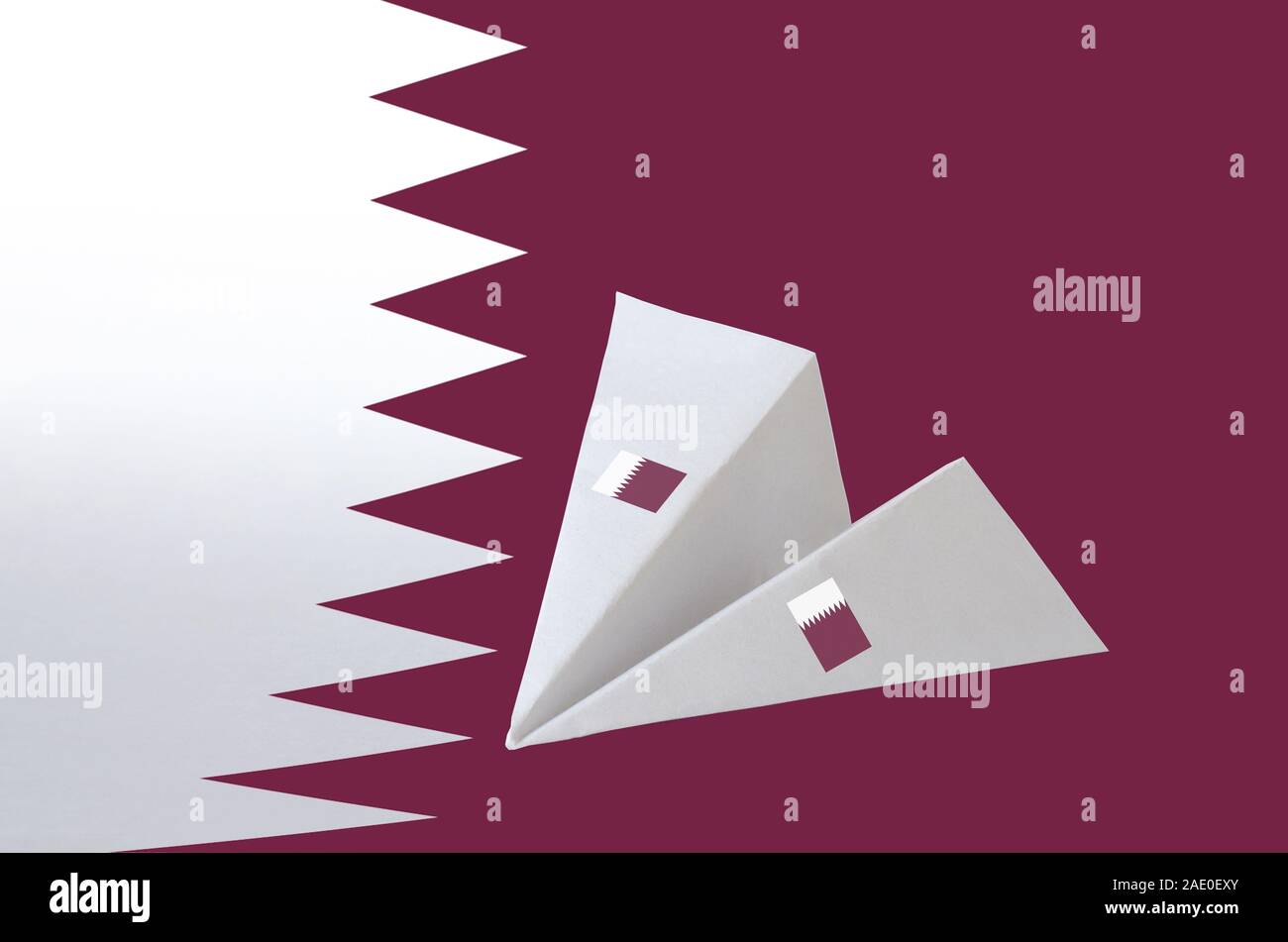 Qatar flag depicted on paper origami airplane. Oriental handmade arts ...