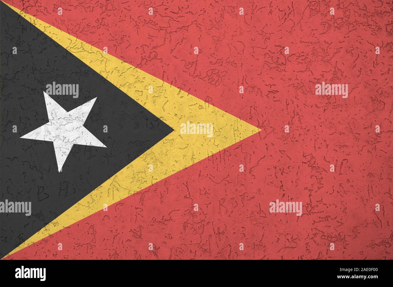 Timor Leste flag depicted in bright paint colors on old relief ...