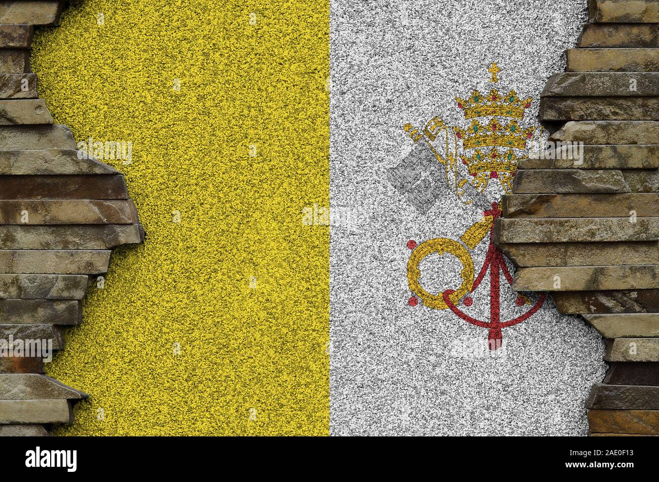 Vatican City State flag depicted in paint colors on old stone wall ...