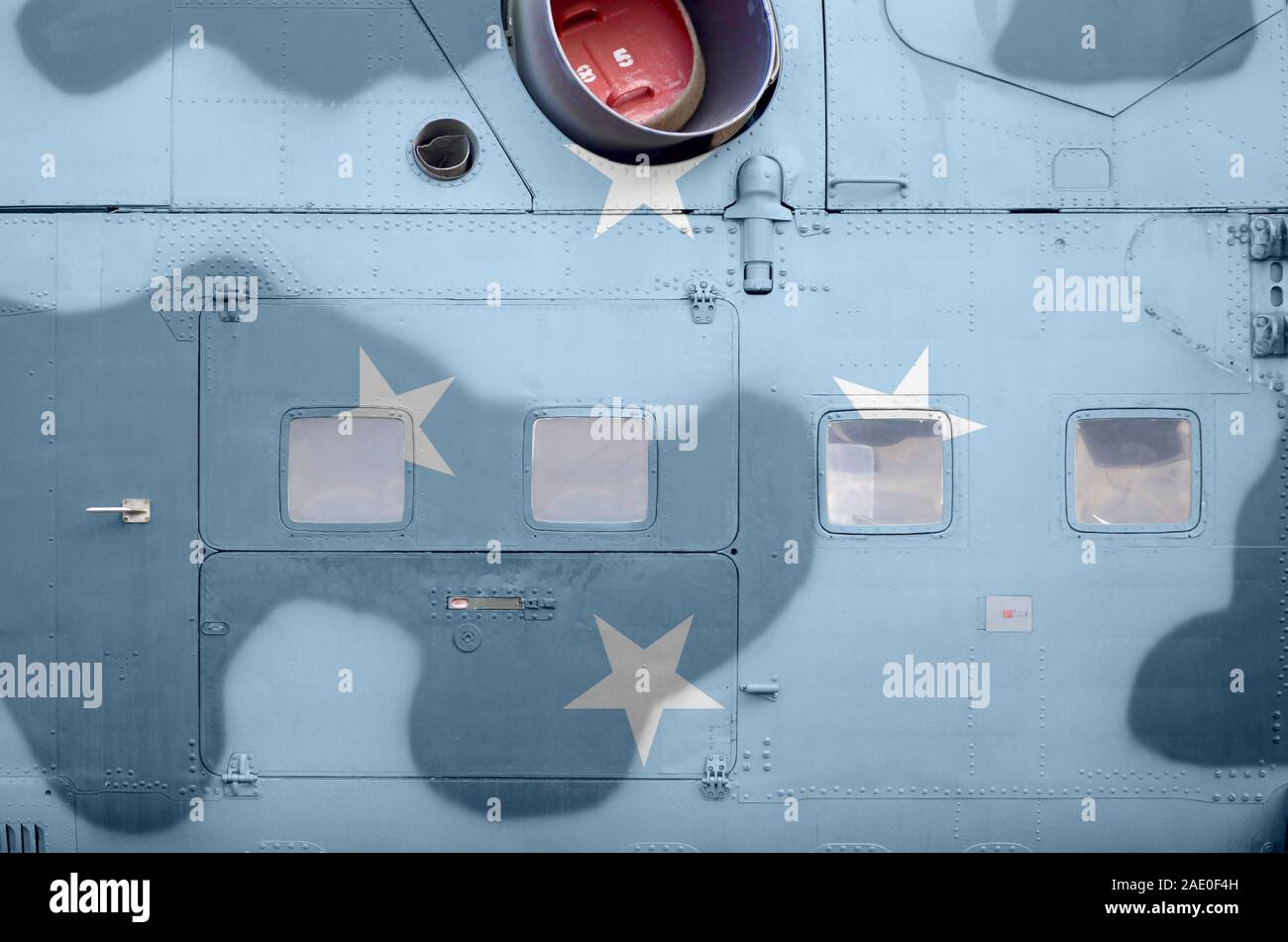 Micronesia flag depicted on side part of military armored helicopter ...