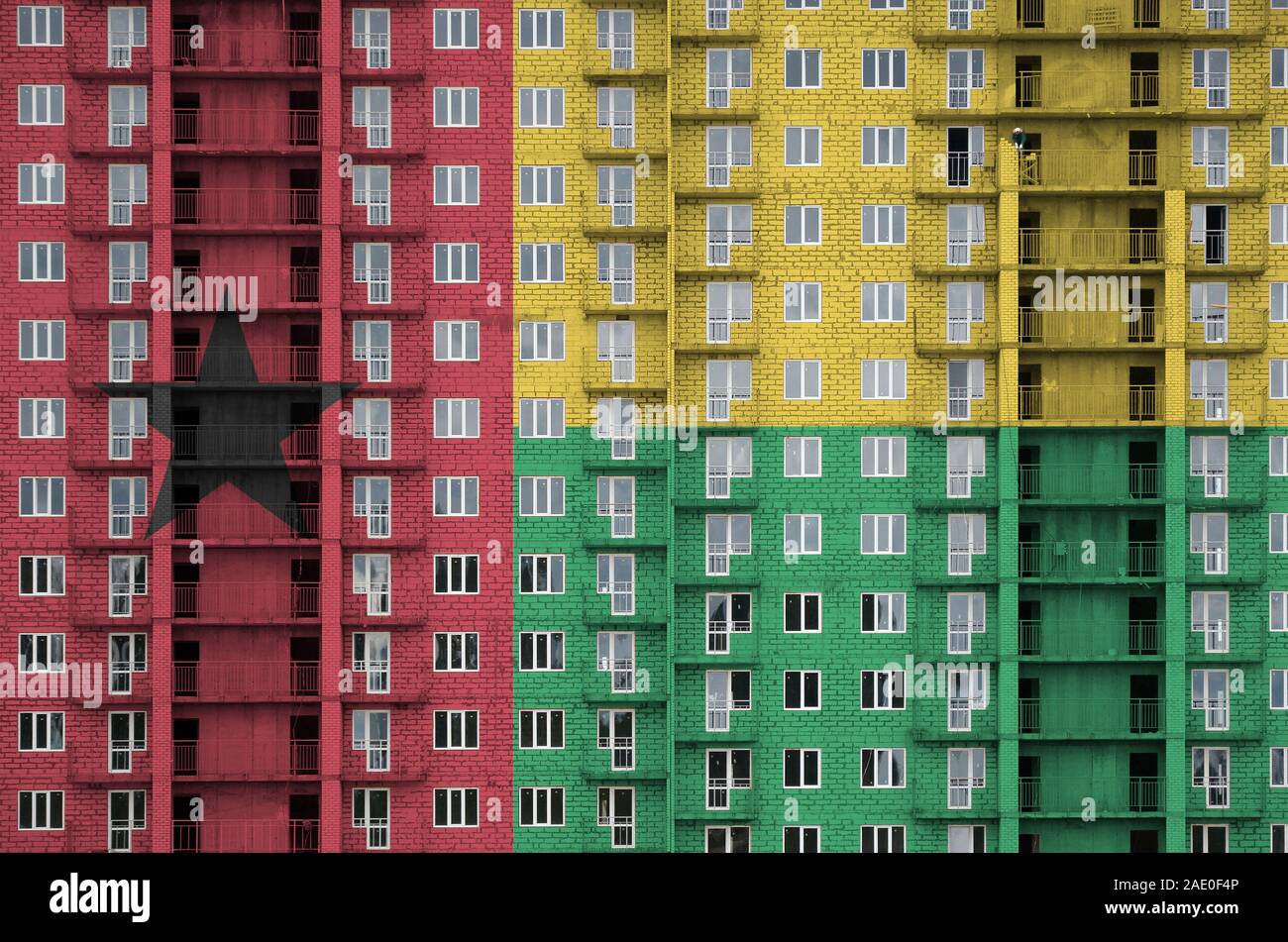 Guinea Bissau flag depicted in paint colors on multi-storey residental ...