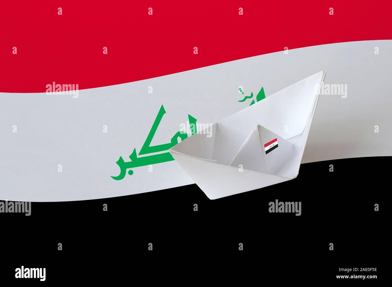 Iraq flag depicted on paper origami ship closeup. Oriental handmade ...