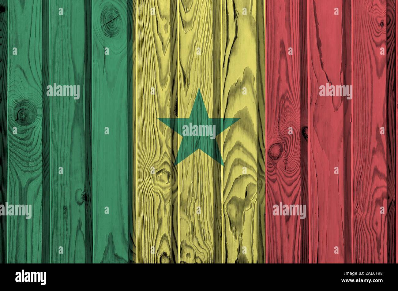 Senegal flag depicted in bright paint colors on old wooden wall close ...