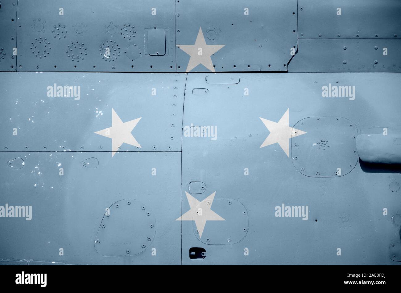 Micronesia flag depicted on side part of military armored helicopter ...