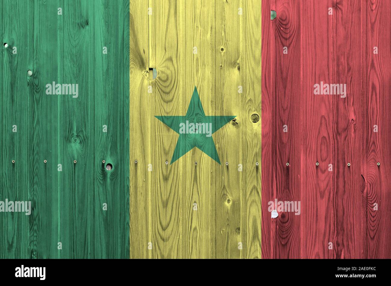 Senegal flag depicted in bright paint colors on old wooden wall close ...