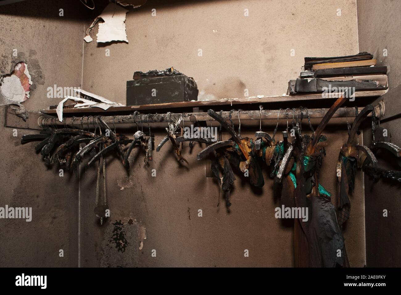 Burnt closet and hangers inside a closet destroyed by fire damage ...