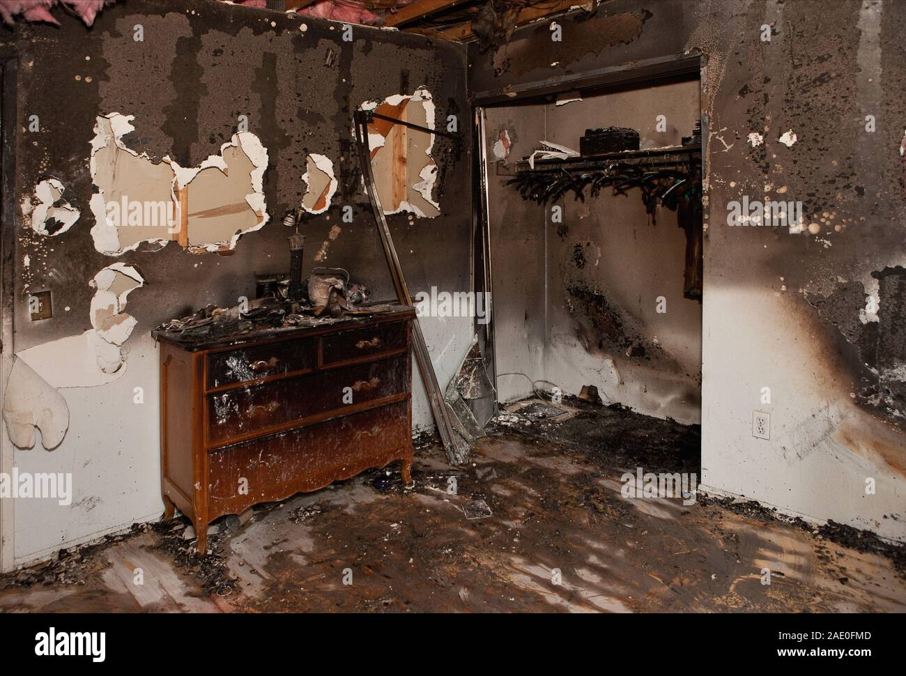 Burnt bedroom wooden dresser and closet inside a home ravaged by a fire ...
