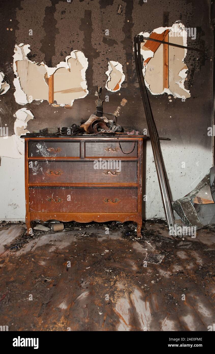 Burnt bedroom wooden dresser inside a home ravaged by a fire Stock ...
