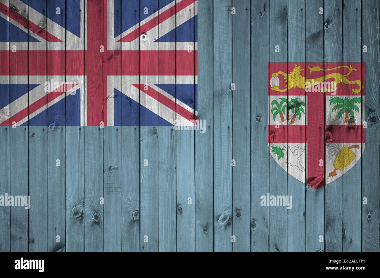 Fiji flag depicted in bright paint colors on old wooden wall close up ...