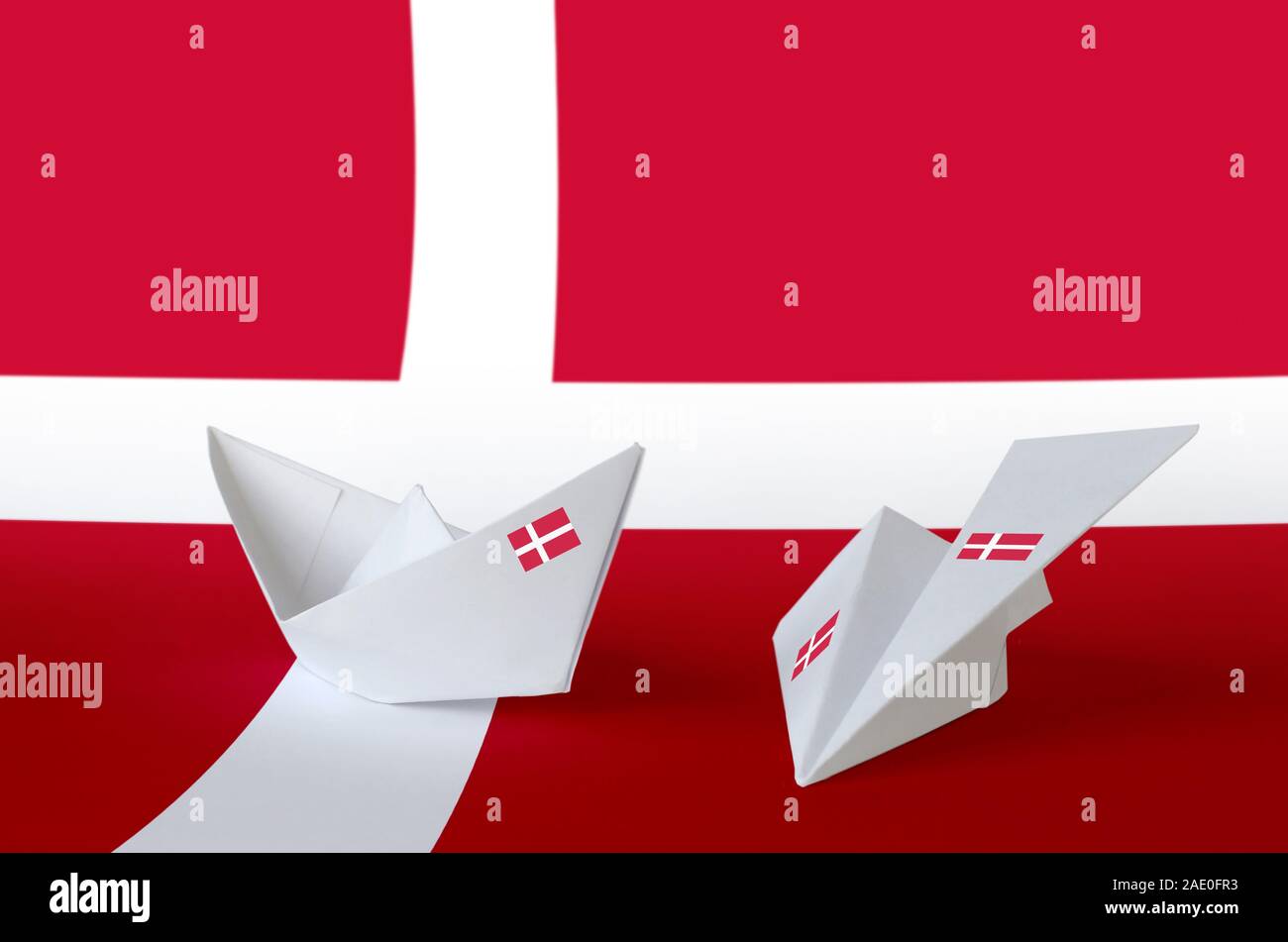 Denmark flag depicted on paper origami airplane and boat. Oriental ...