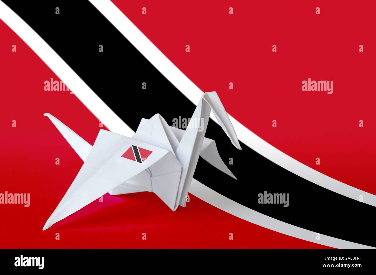 Trinidad and Tobago flag depicted on paper origami crane wing. Oriental ...