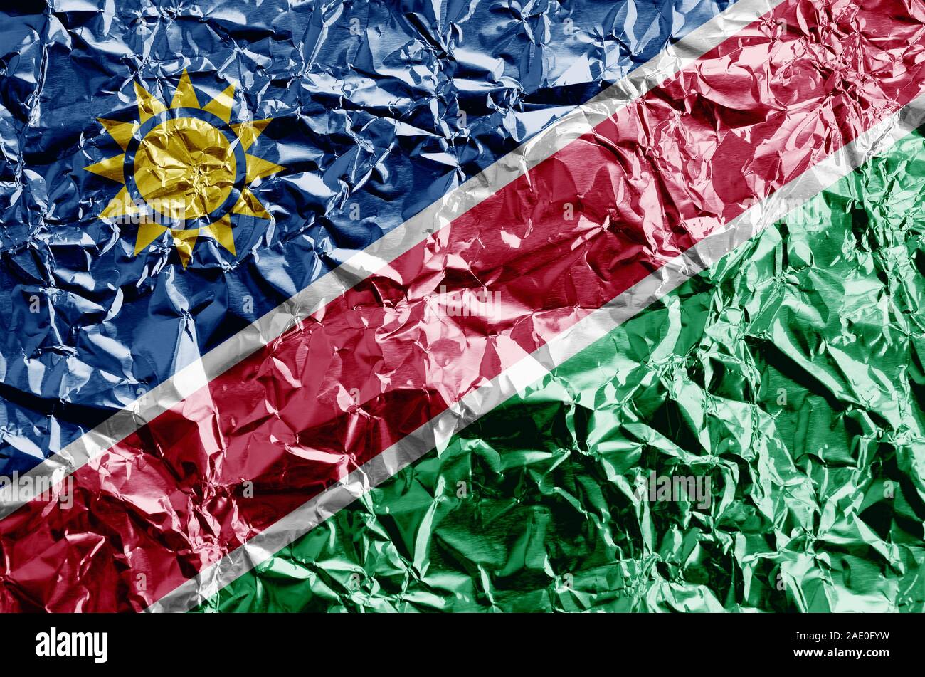 Namibia flag depicted in paint colors on shiny crumpled aluminium foil ...