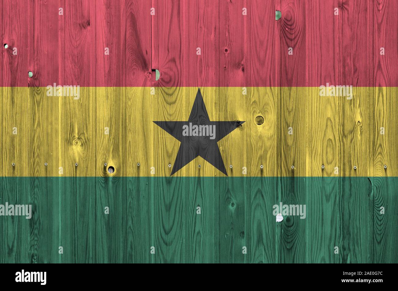 Ghana flag depicted in bright paint colors on old wooden wall close up ...