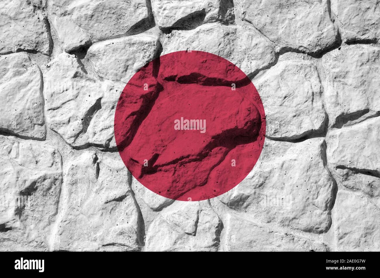 Japan flag depicted in paint colors on old stone wall close up ...