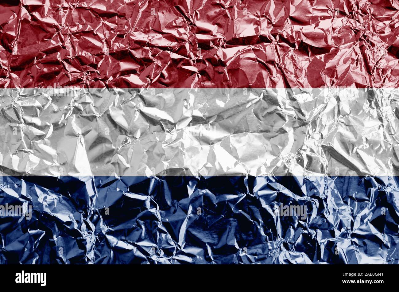 Netherlands flag depicted in paint colors on shiny crumpled aluminium ...