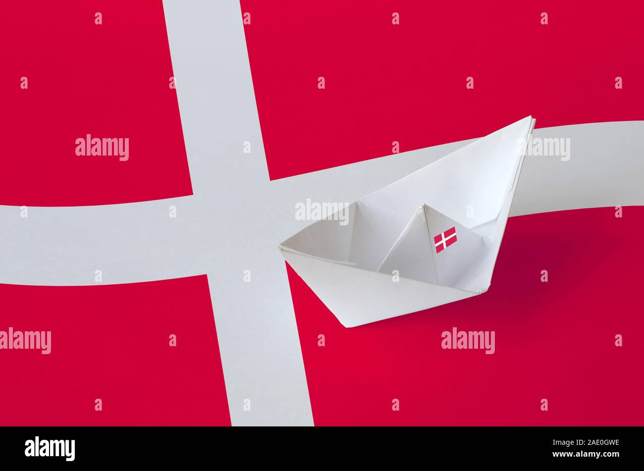 Denmark flag depicted on paper origami ship closeup. Oriental handmade ...