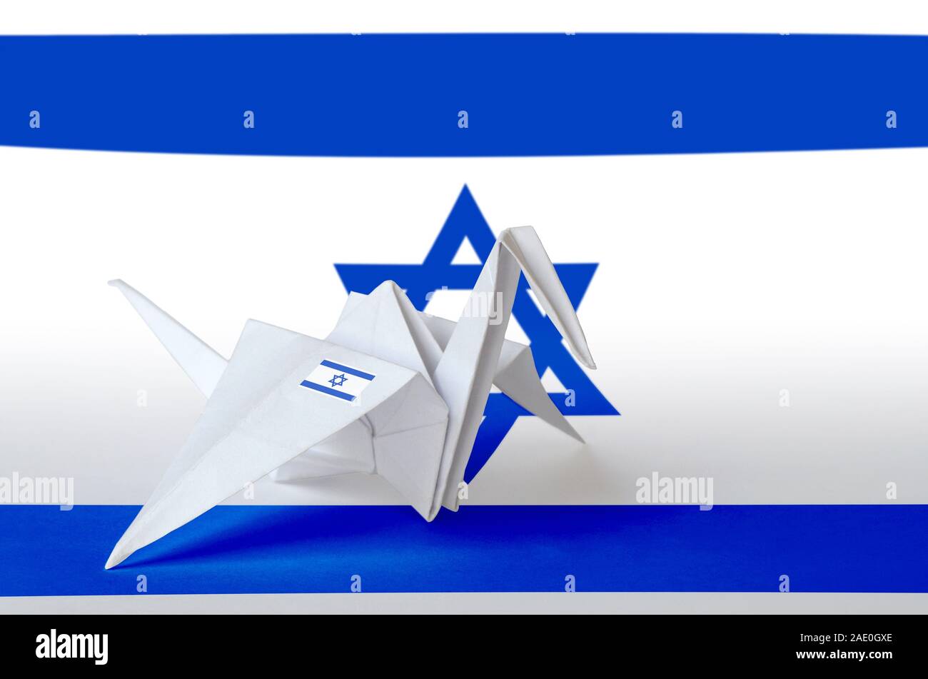 Israel flag depicted on paper origami crane wing. Oriental handmade ...