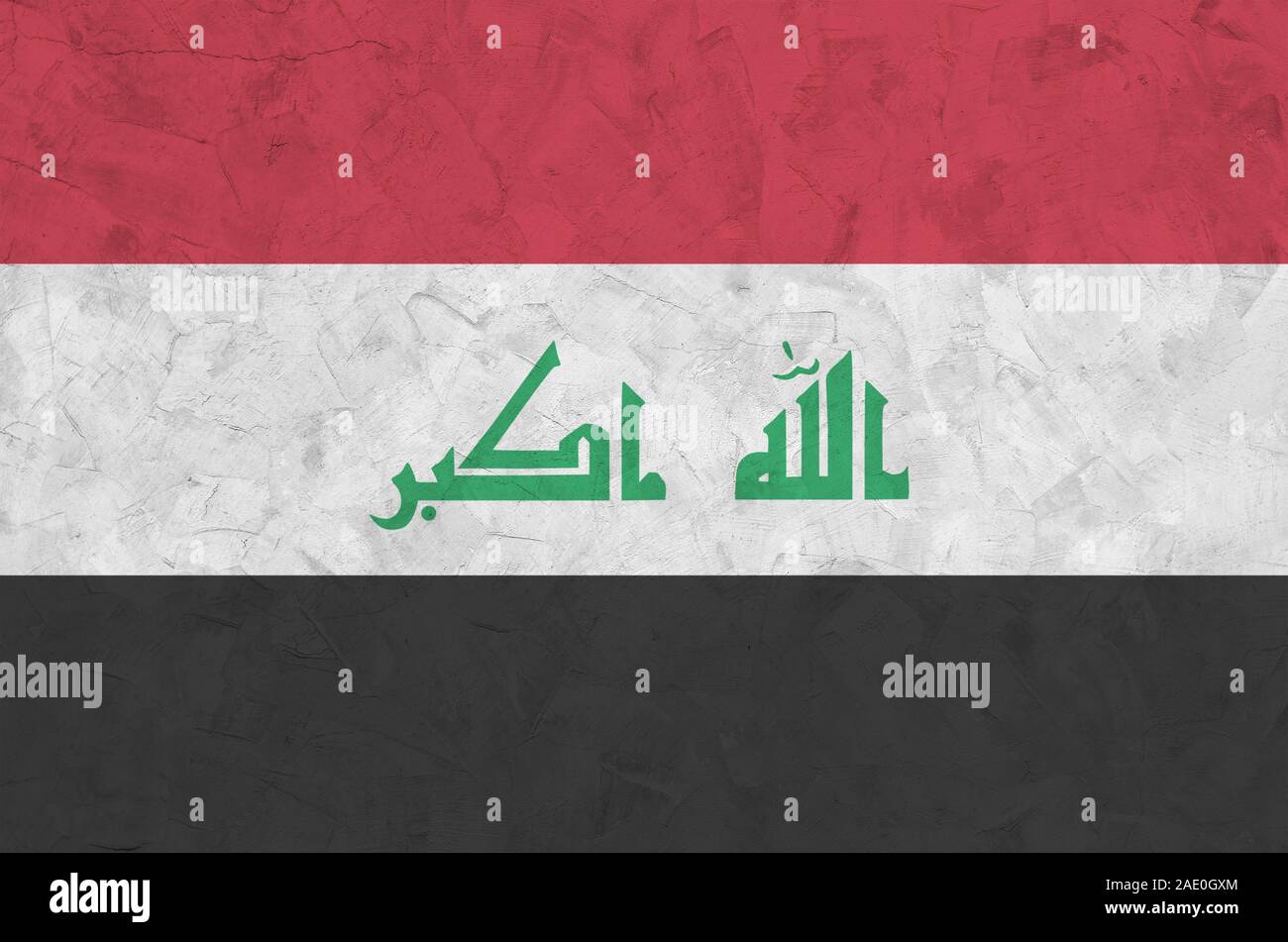 Iraq flag depicted in bright paint colors on old relief plastering wall ...