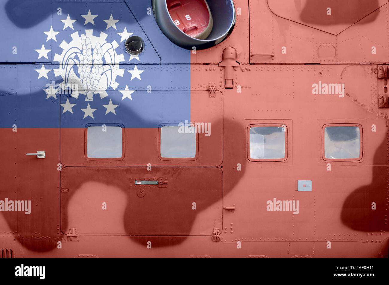 Myanmar flag depicted on side part of military armored helicopter close ...