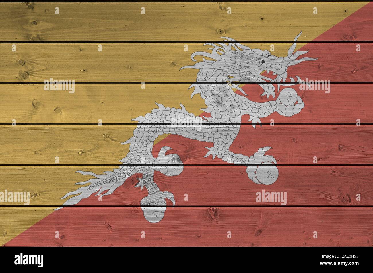 Bhutan flag depicted in bright paint colors on old wooden wall close up ...