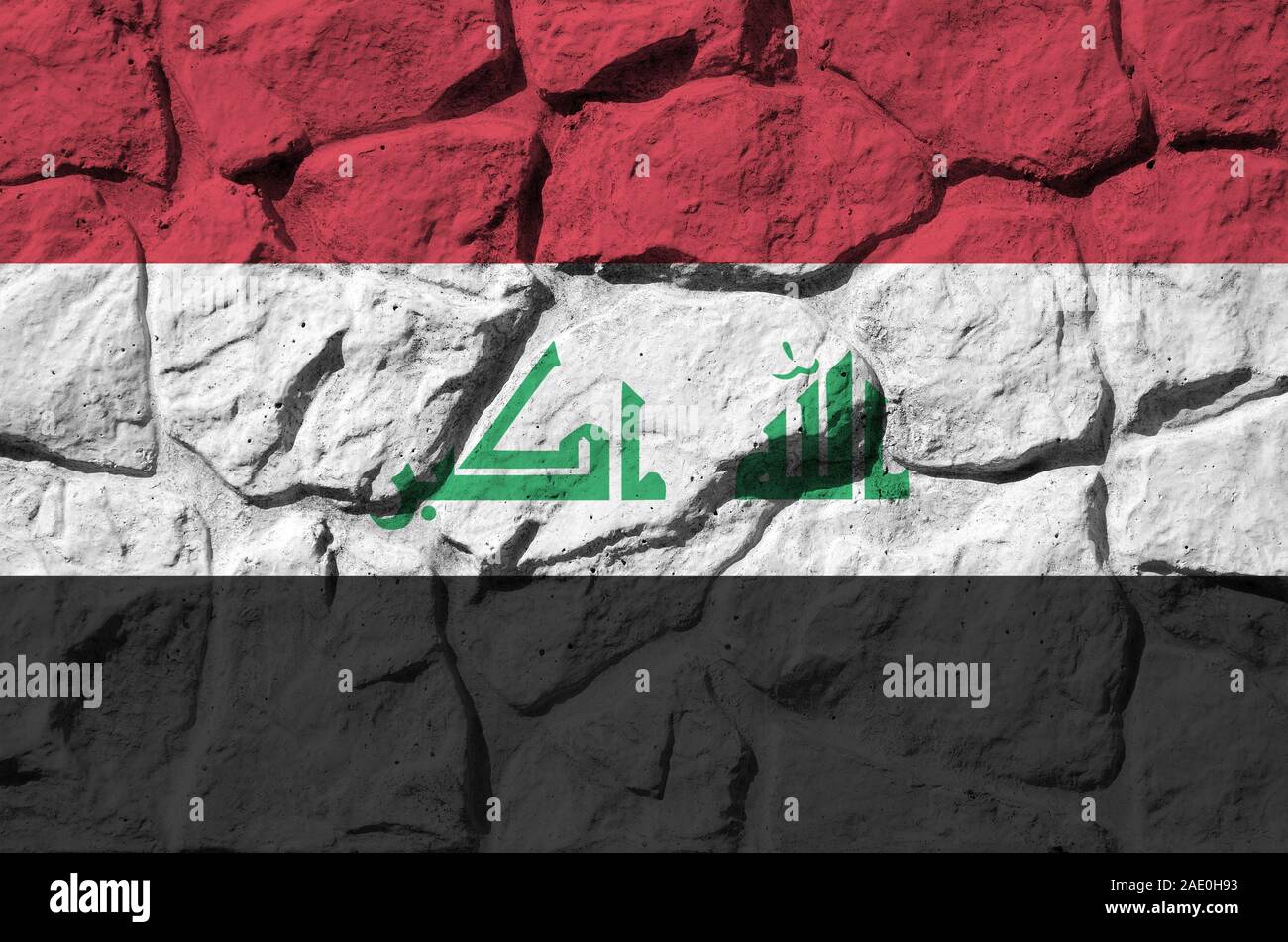 Iraq flag depicted in paint colors on old stone wall close up. Textured ...