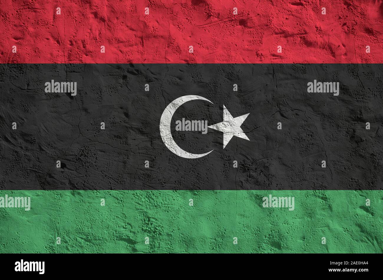 Libya flag depicted in bright paint colors on old relief plastering ...