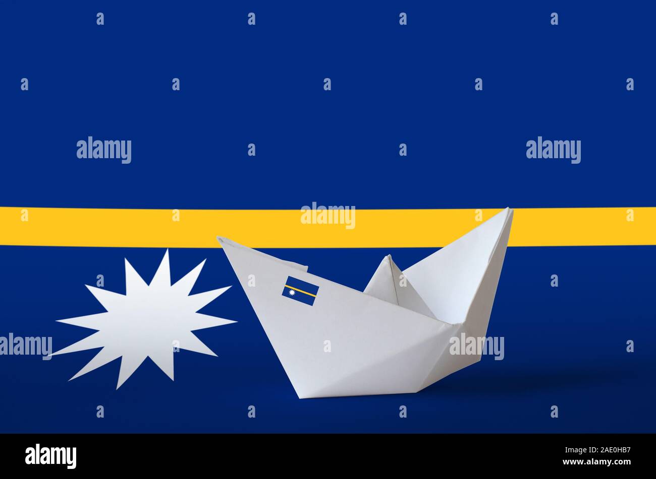 Nauru flag depicted on paper origami ship closeup. Oriental handmade ...