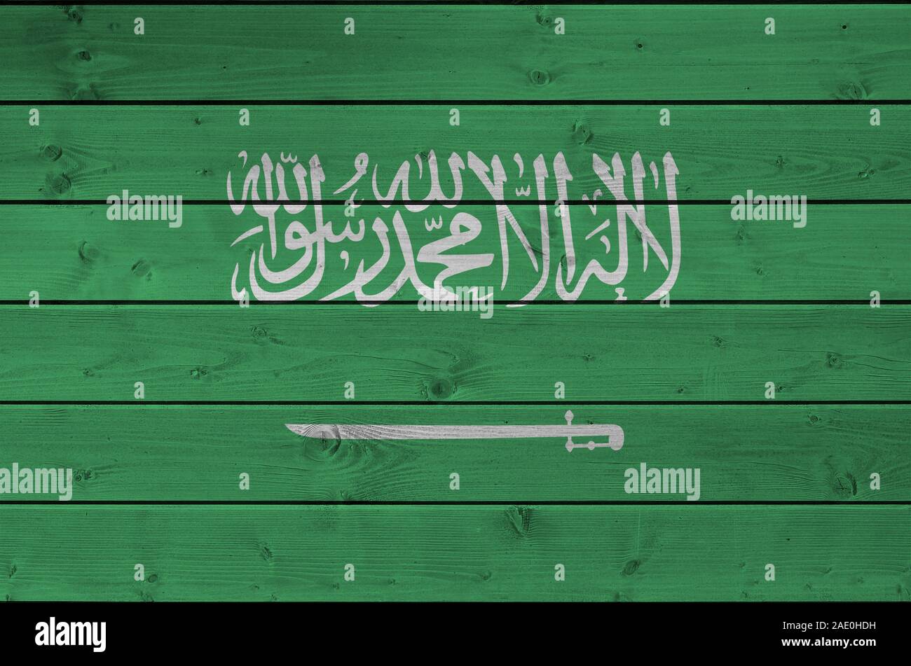 Saudi Arabia flag depicted in bright paint colors on old wooden wall ...