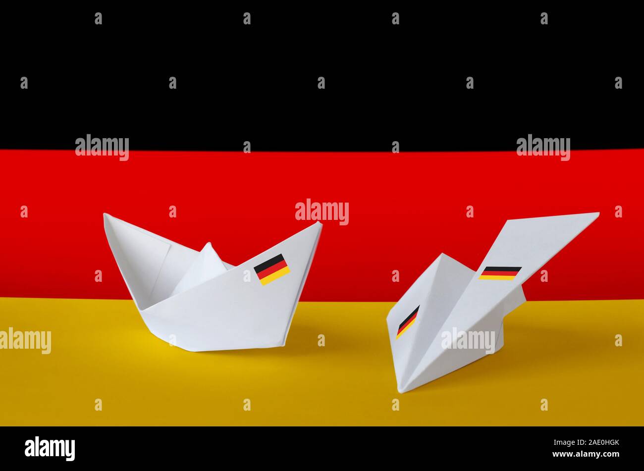 Germany flag depicted on paper origami airplane and boat. Oriental ...