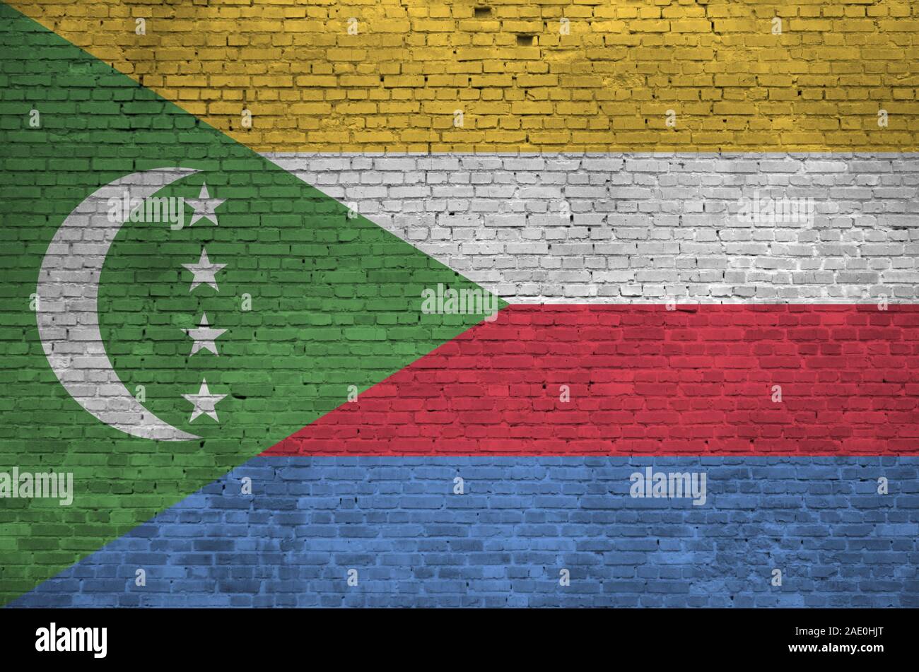 Comoros flag depicted in paint colors on old brick wall close up ...