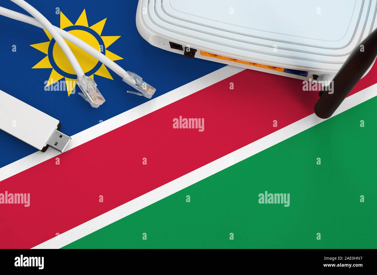 Namibia flag depicted on table with internet rj45 cable, wireless usb ...