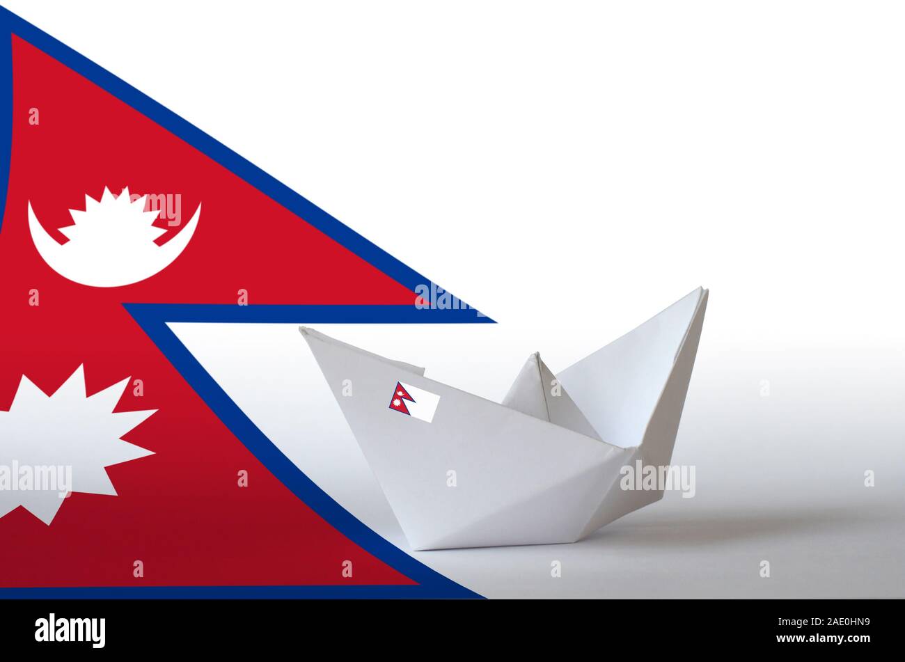 Nepal flag depicted on paper origami ship closeup. Oriental handmade ...