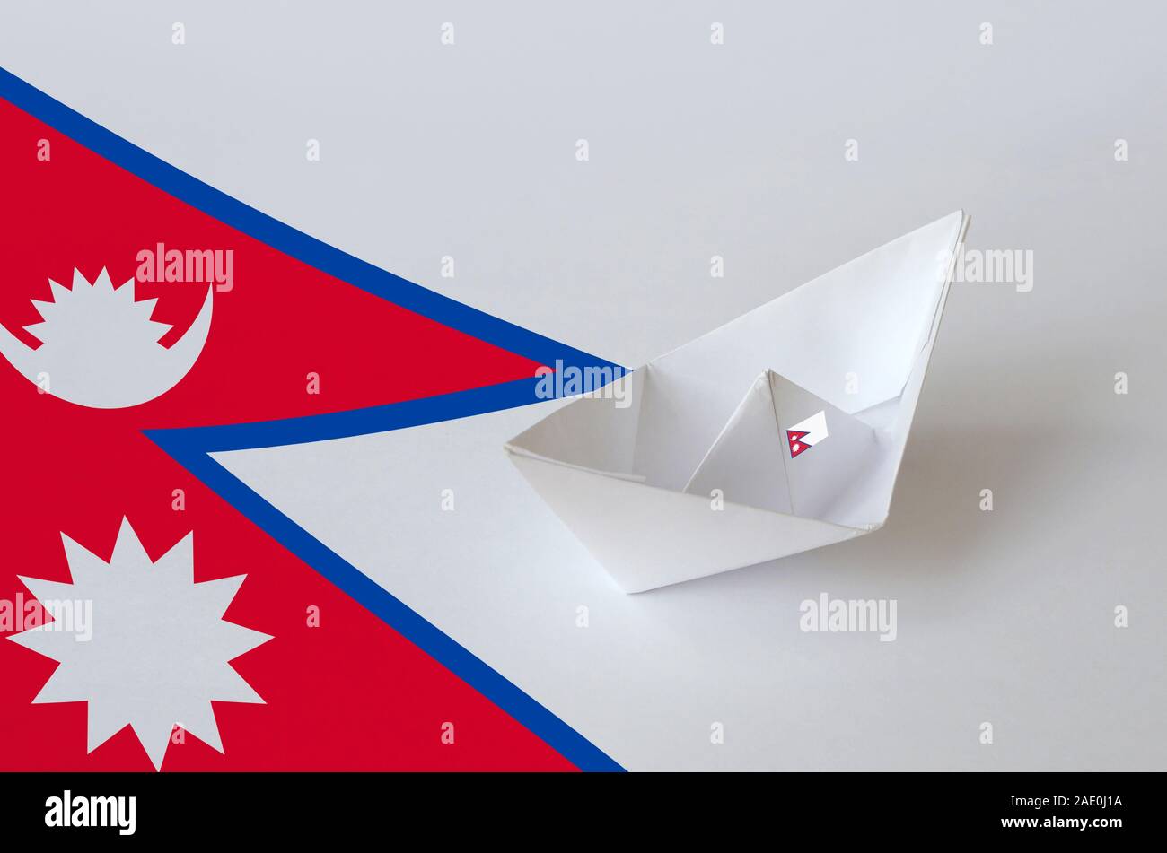 Nepal flag depicted on paper origami ship closeup. Oriental handmade ...
