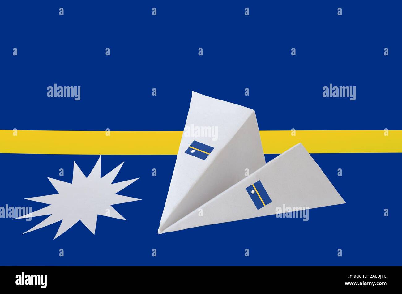 Nauru flag depicted on paper origami airplane. Oriental handmade arts ...