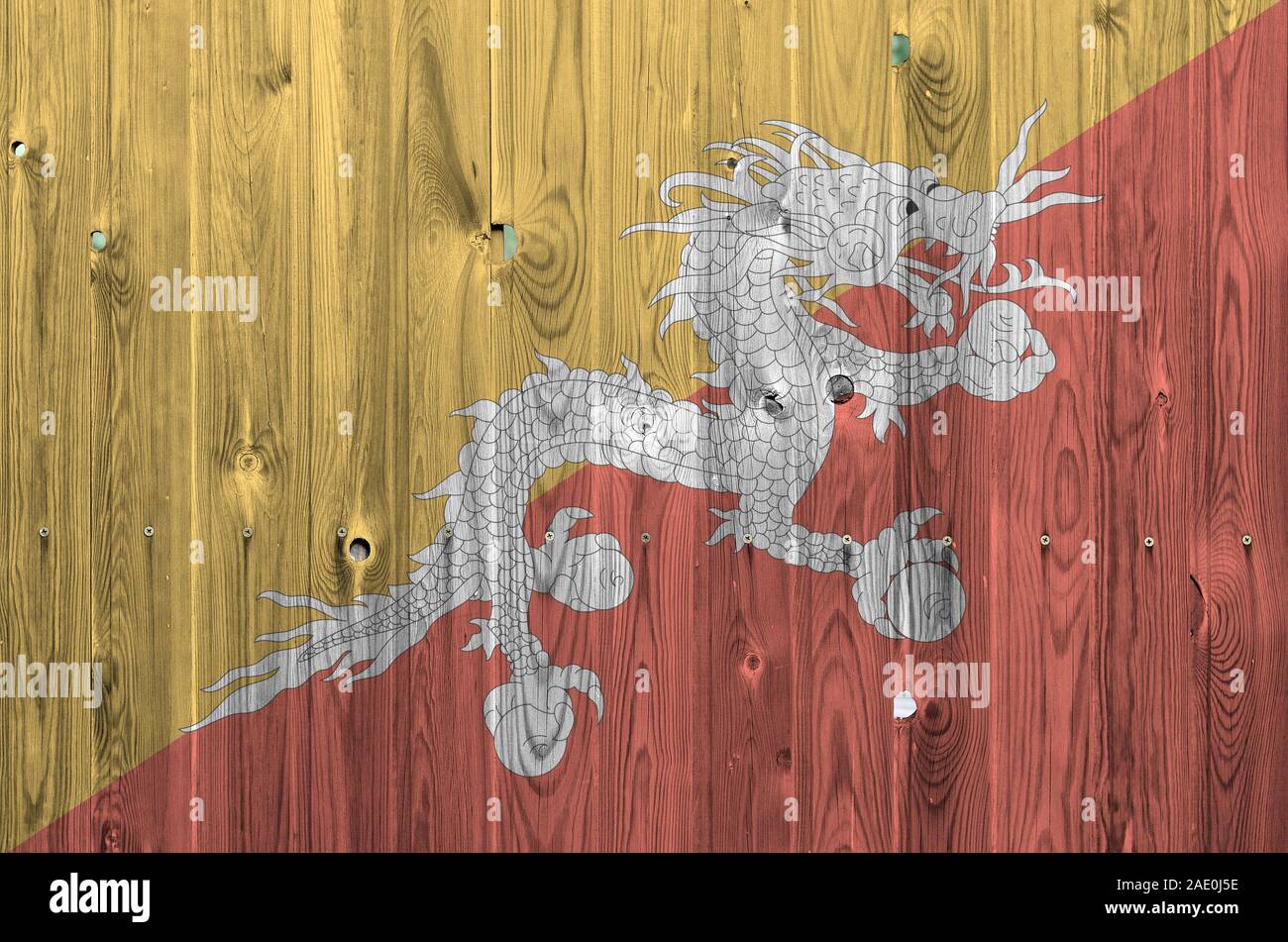 Bhutan flag depicted in bright paint colors on old wooden wall close up ...