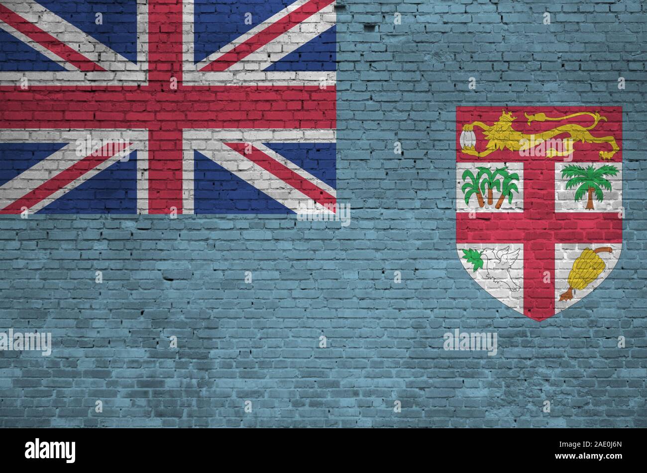Fiji flag depicted in paint colors on old brick wall close up. Textured ...