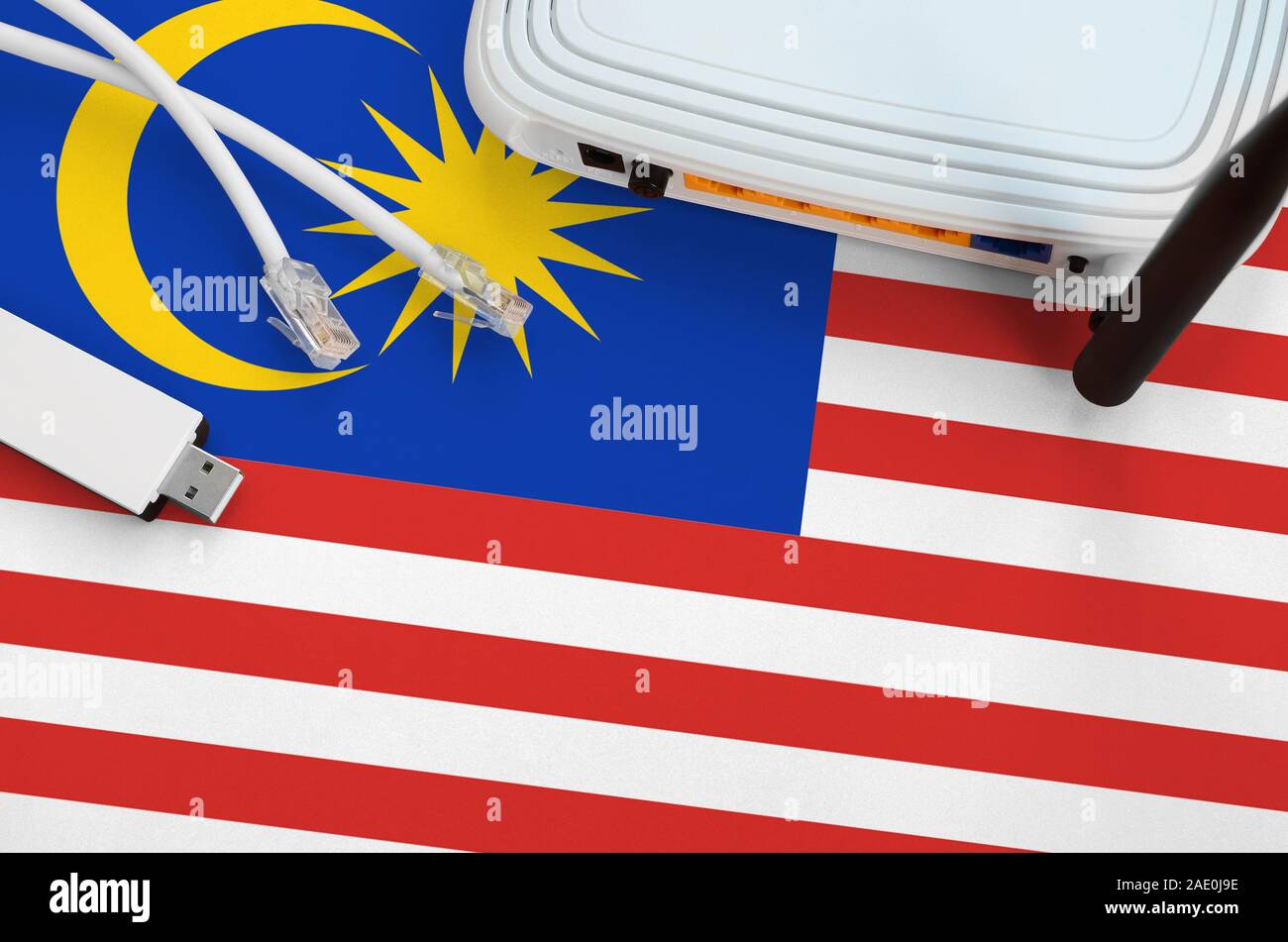 Malaysia flag depicted on table with internet rj45 cable, wireless usb ...