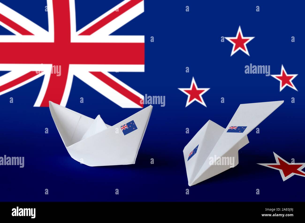New Zealand flag depicted on paper origami airplane and boat. Oriental ...