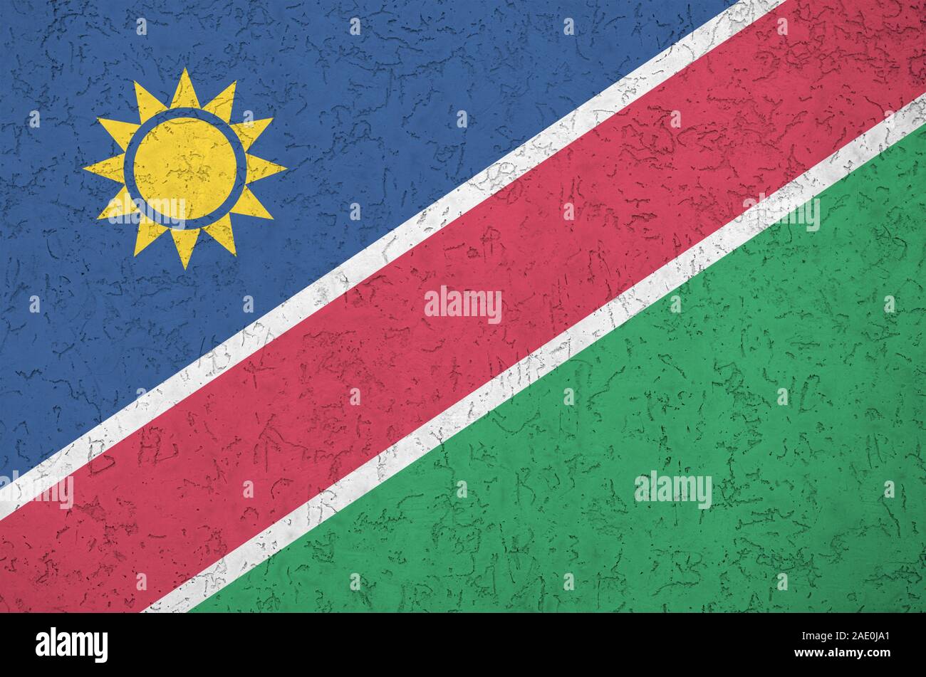 Namibia flag depicted in bright paint colors on old relief plastering ...