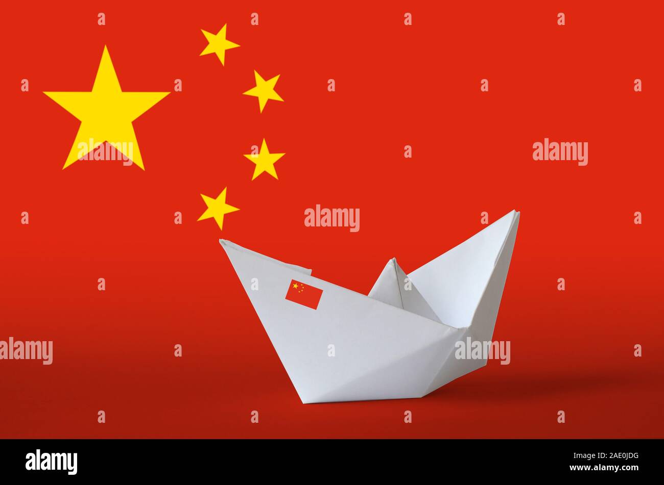 China flag depicted on paper origami ship closeup. Oriental handmade ...